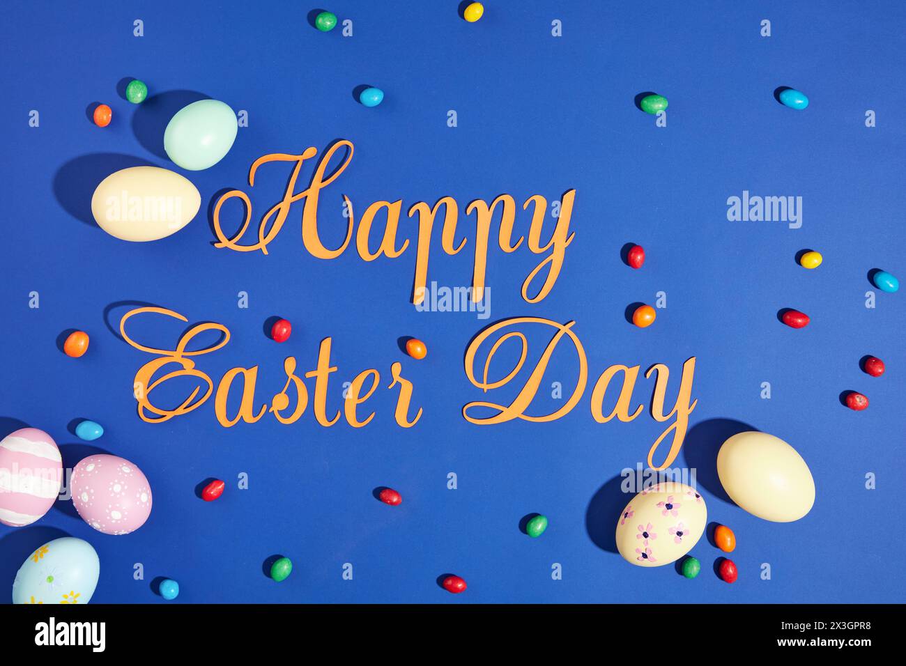 Some letters made of yellow paper combined form the text Happy Easter ...