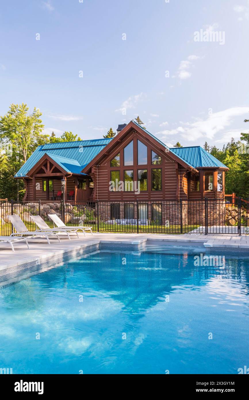 In-ground salt water swimming pool and brown stained milled Eastern ...