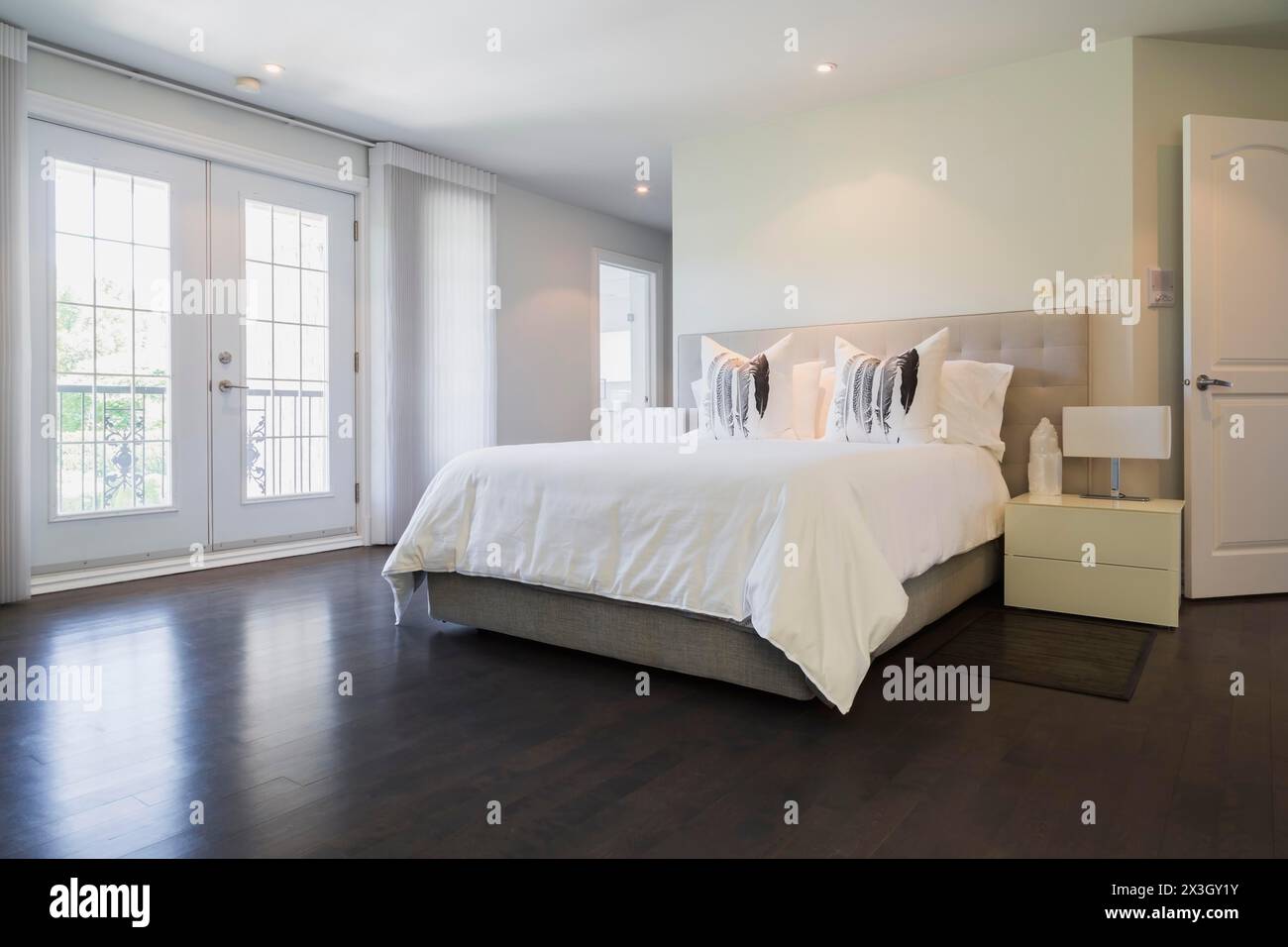 Master bedroom with queen size bed, white lacquered nightstands and ...