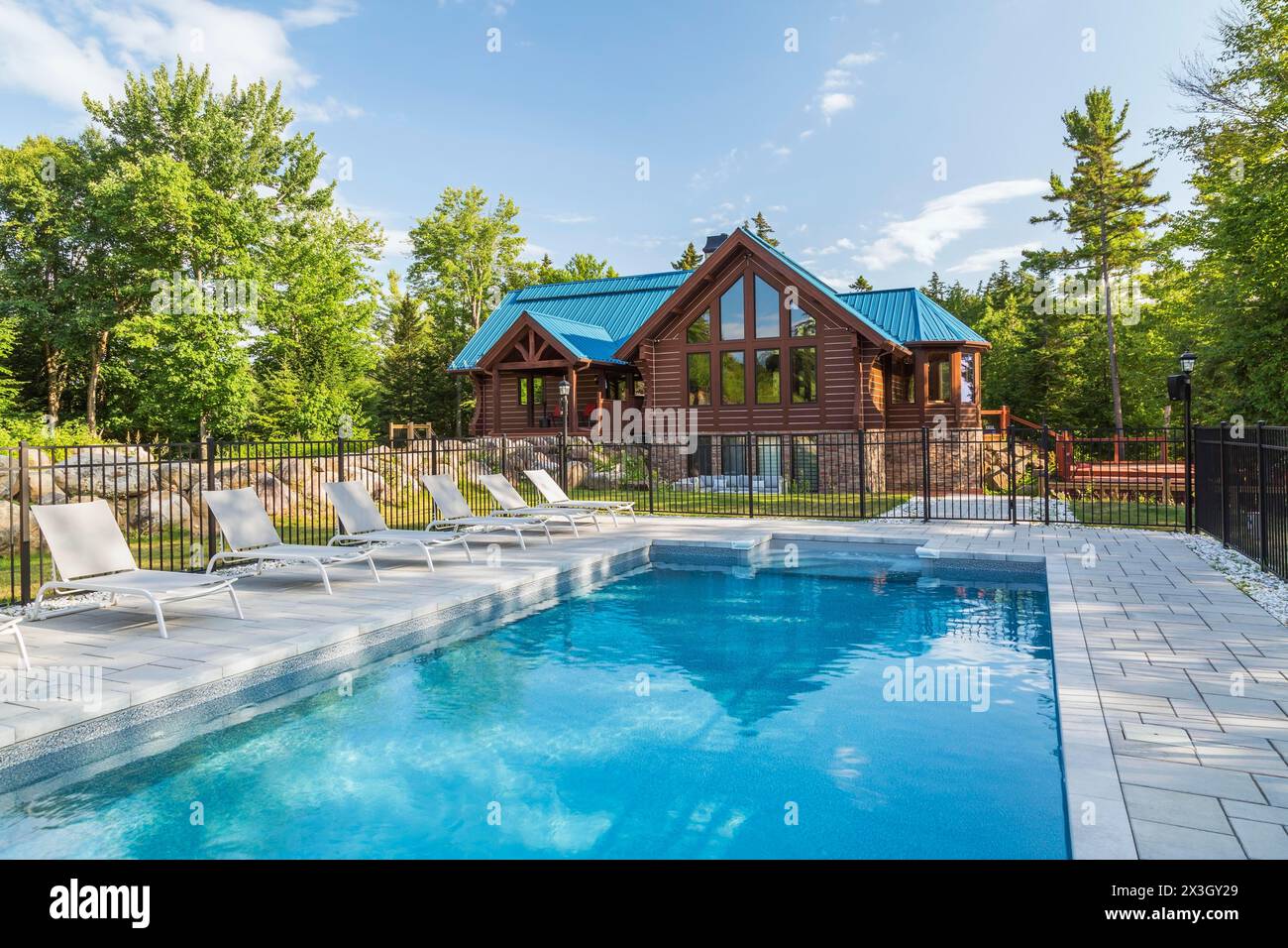 In-ground salt water swimming pool and brown stained milled Eastern ...