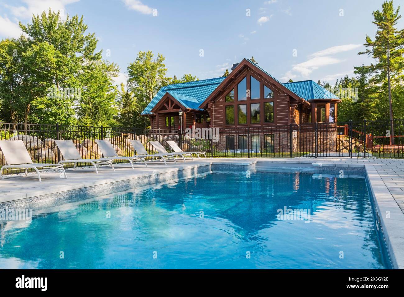 In-ground salt water swimming pool and brown stained milled Eastern ...