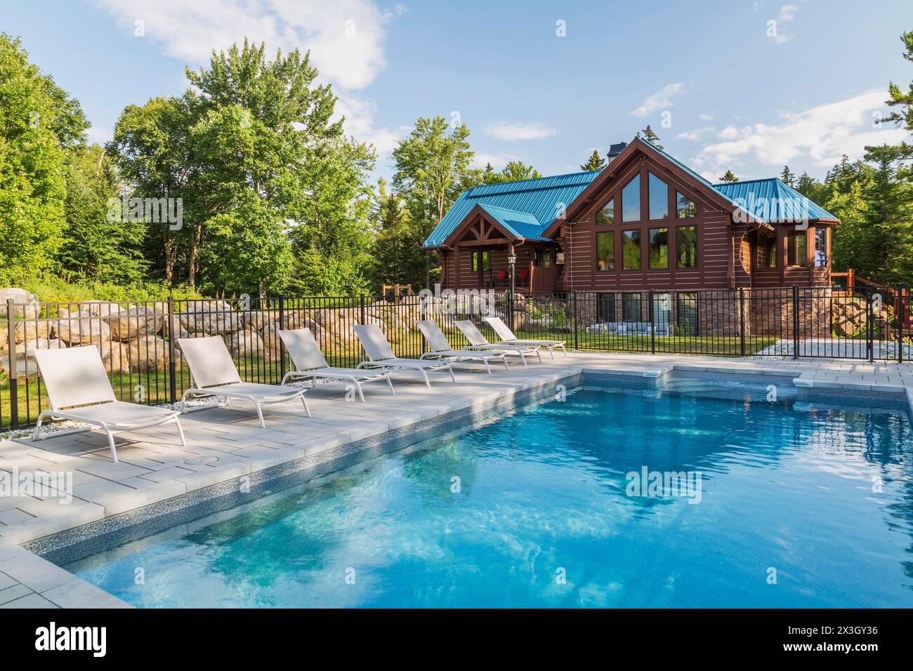 In-ground salt water swimming pool and brown stained milled Eastern ...