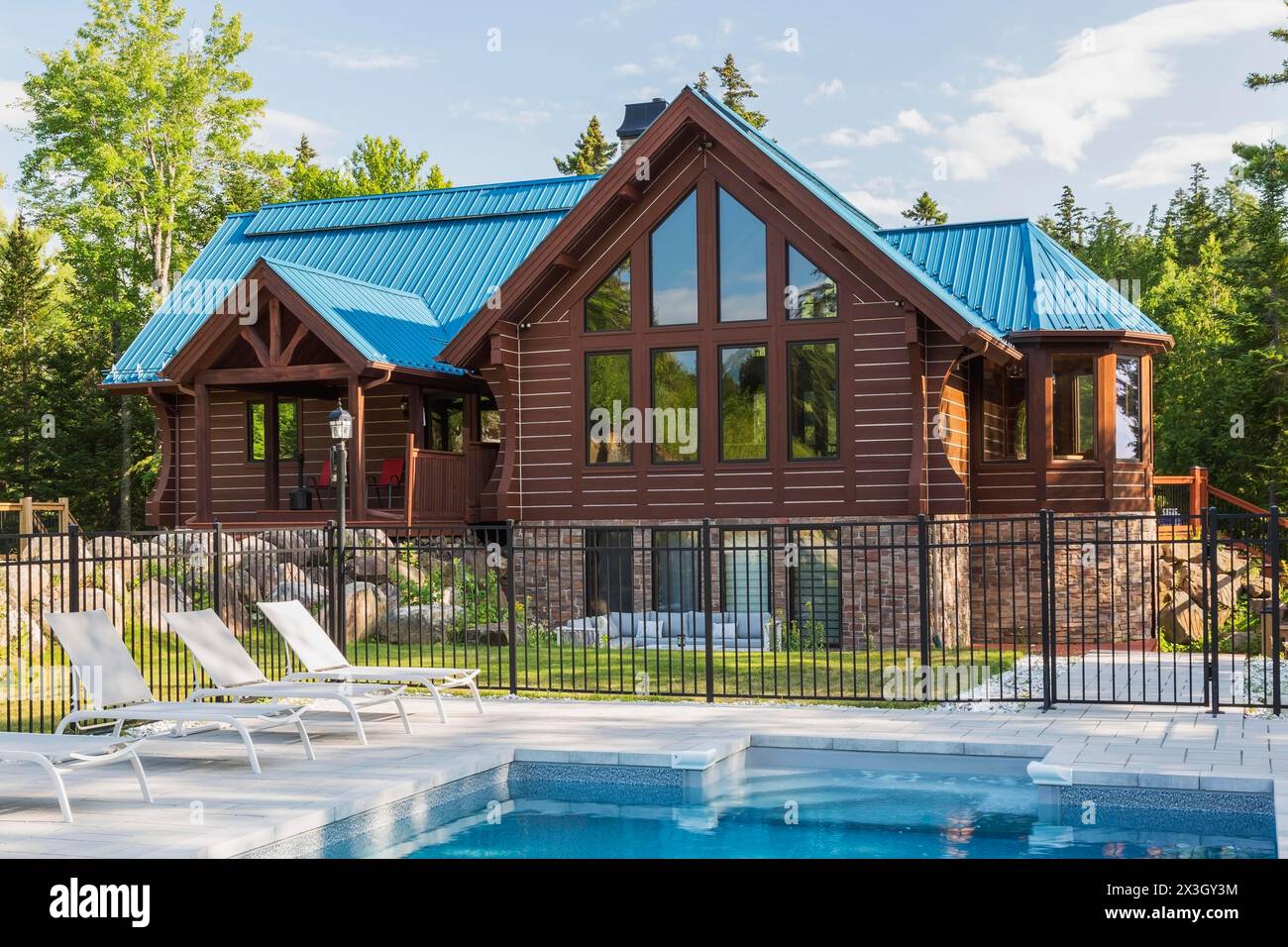 In-ground salt water swimming pool and brown stained milled Eastern ...