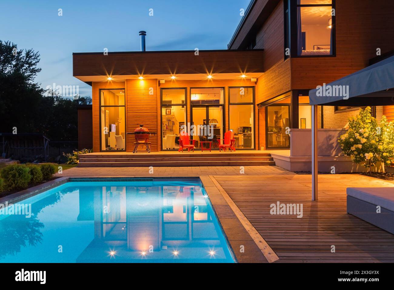 Rear of modern cube style home with stained horizontal wood cladding ...