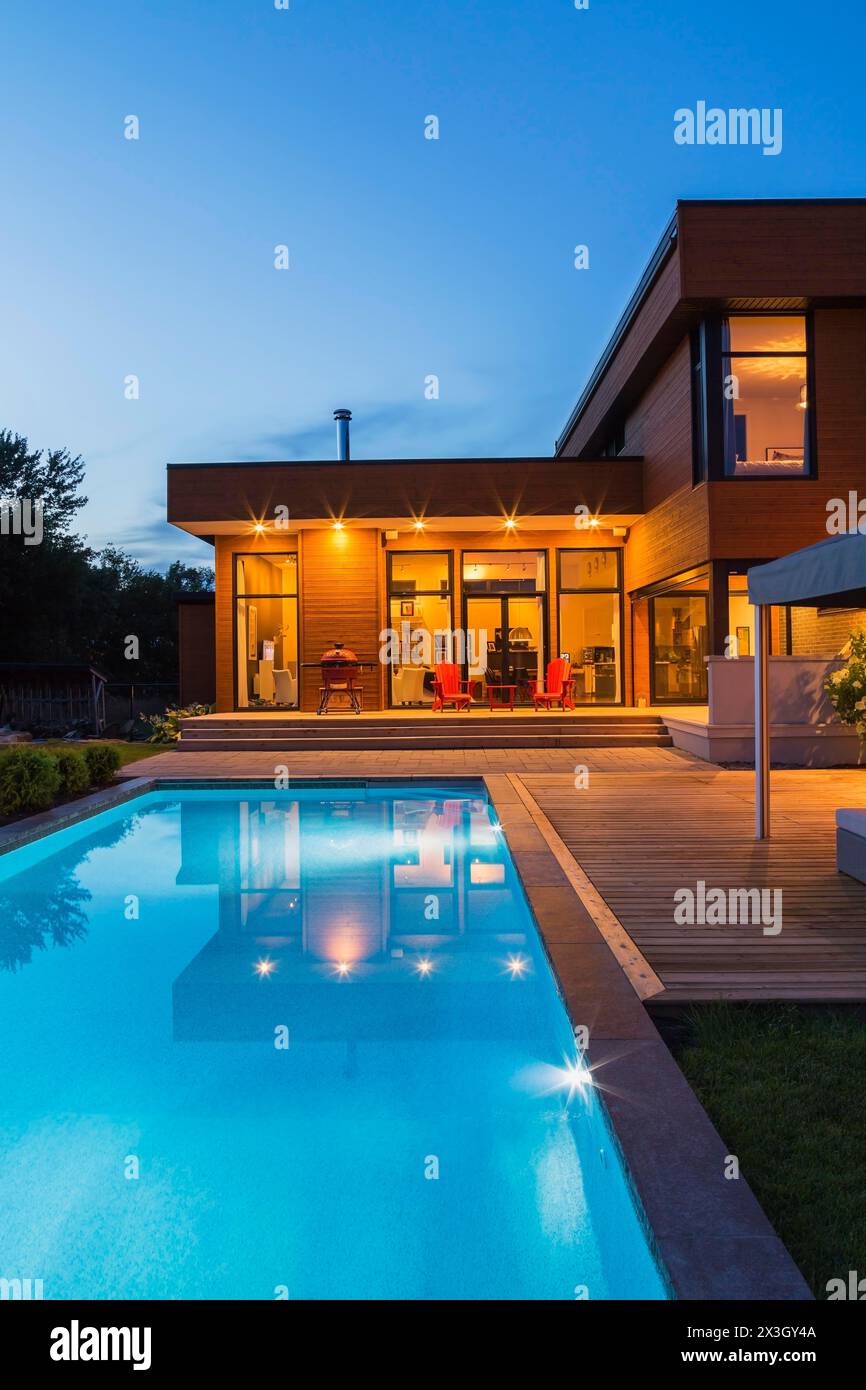 Rear of modern cube style home with stained horizontal wood cladding ...