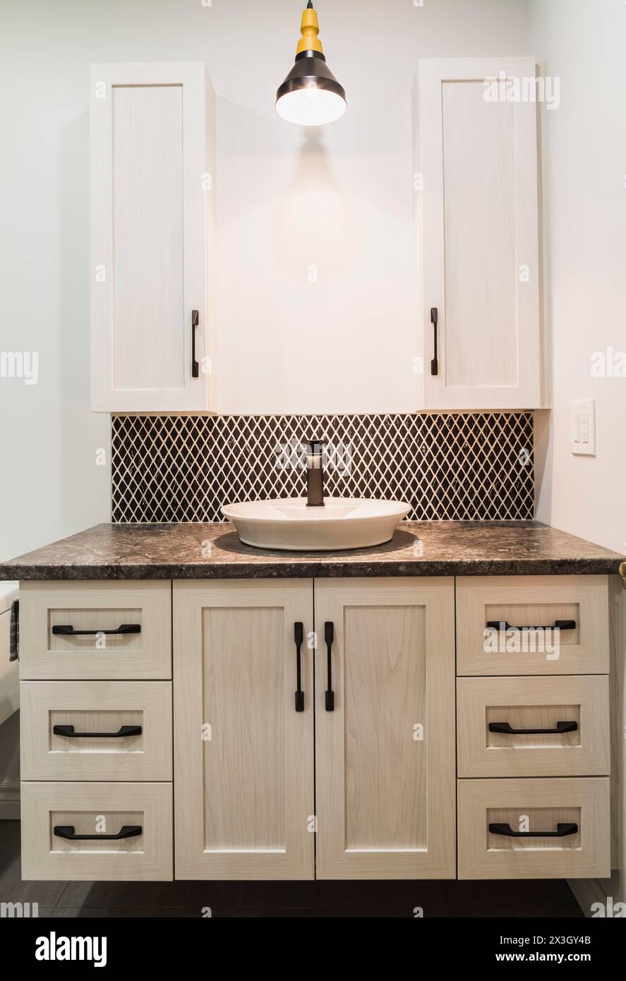 Antique finish wooden cabinet with black nuanced laminated countertop ...