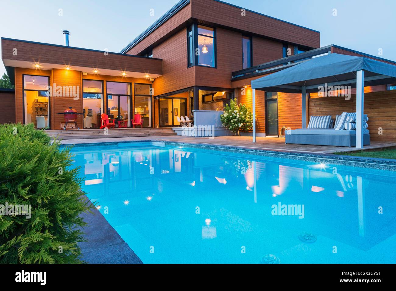 Rear of modern cube style home with stained horizontal wood cladding ...