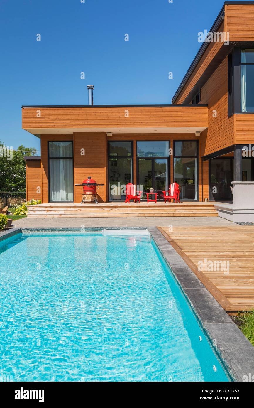 Modern cube style home with stained horizontal wood cladding and in ...