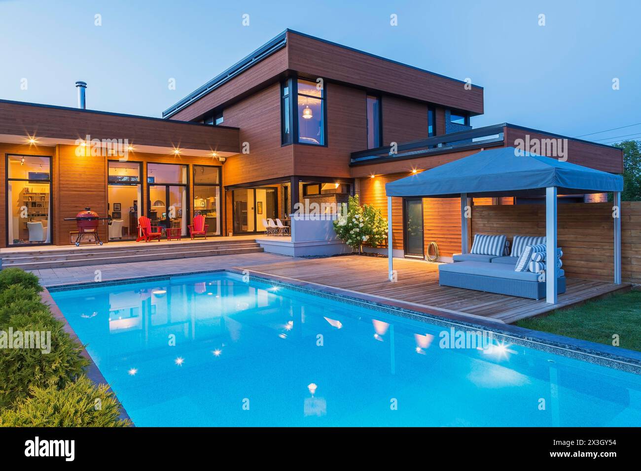 Rear of modern cube style home with stained horizontal wood cladding ...