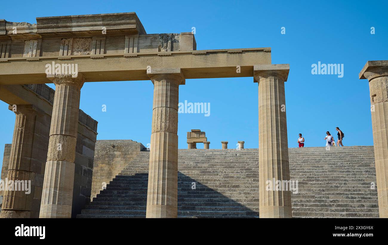 Tourists explore ancient ruins under a clear blue sky, Acropolis of ...