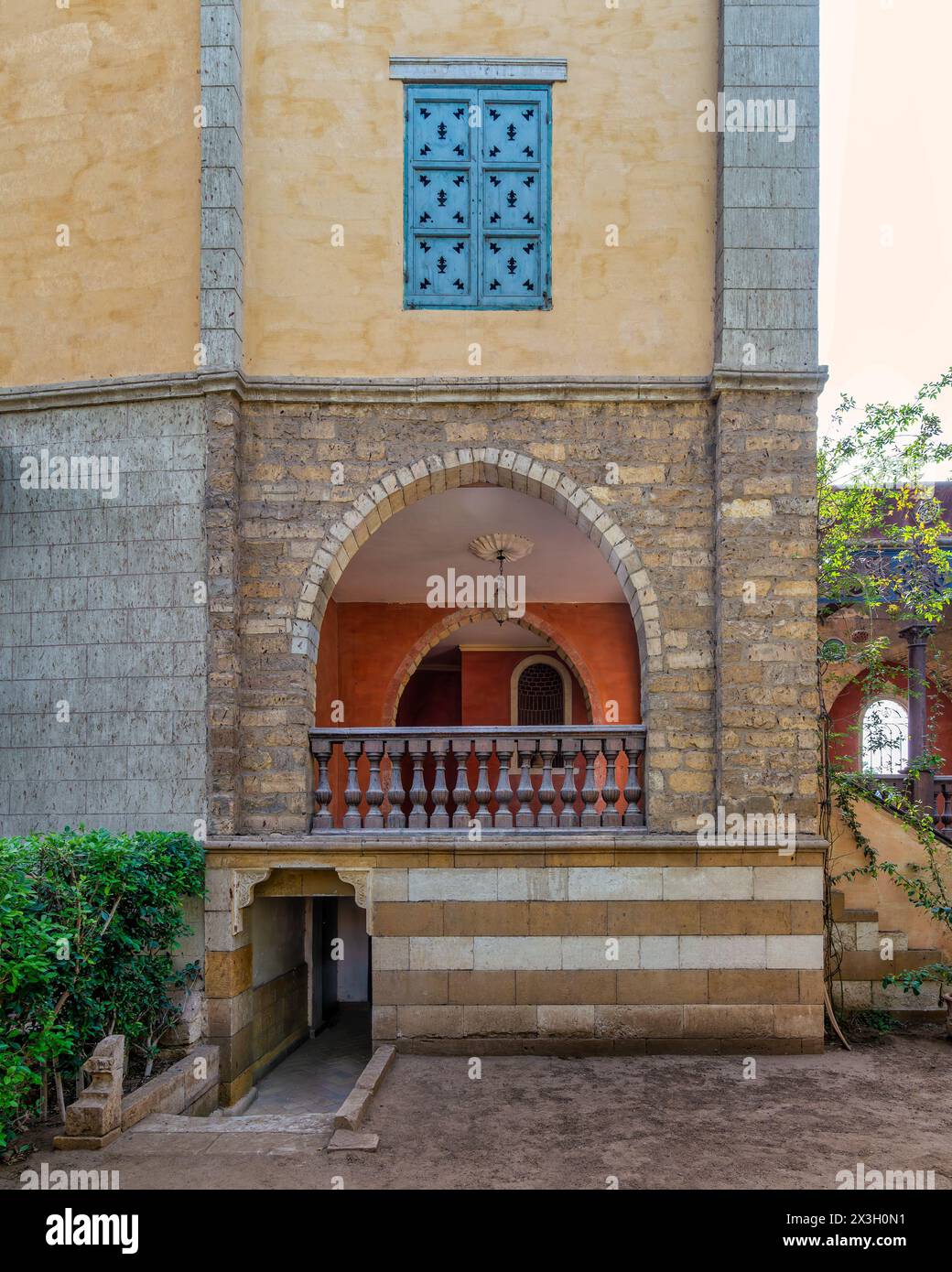 A serene view of a rustic style building featuring an arched wooden ...