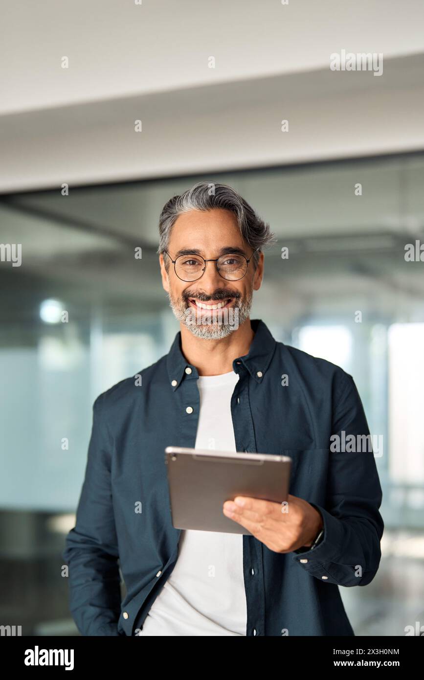 Happy mature business man executive standing in office with tablet ...