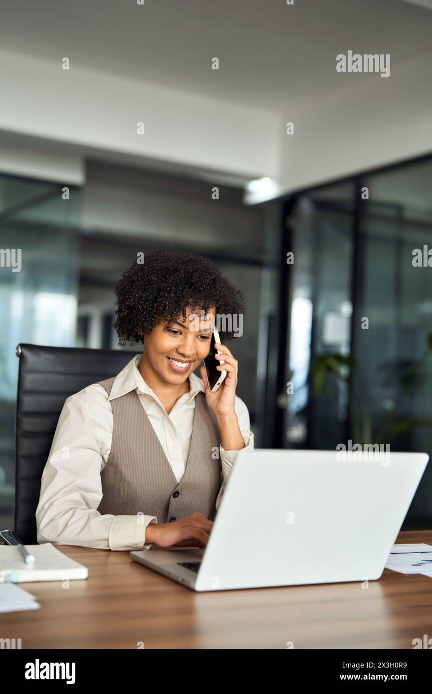 African happy professional woman executive making call talking on phone ...