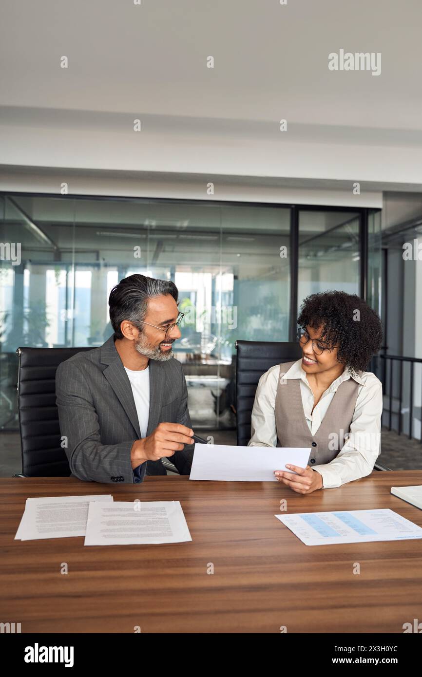 African female financial advisor consulting client investor at meeting ...