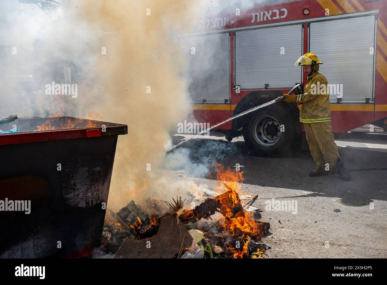 A firefighter puts out a fire lit outside of the designated area ...