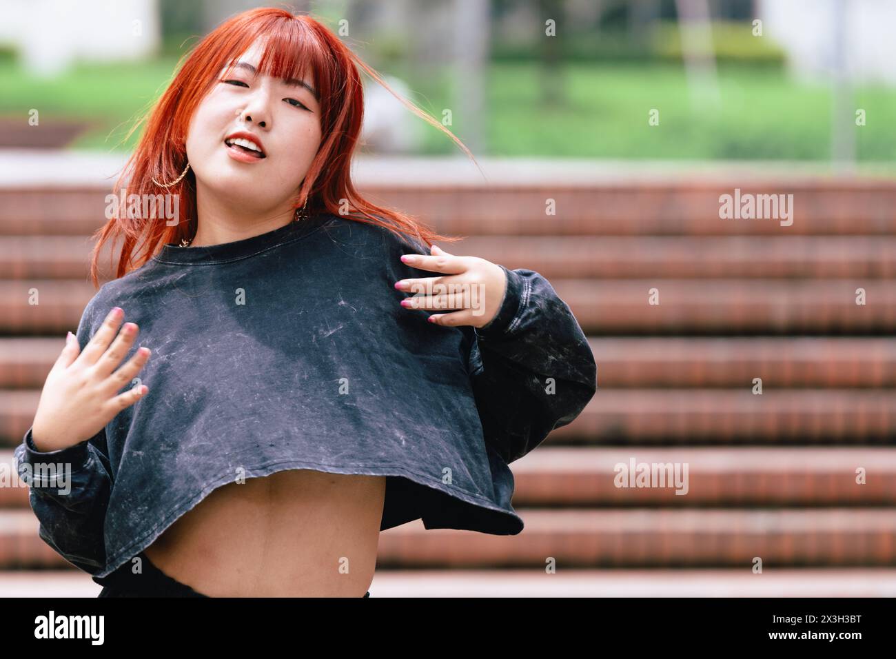 Animated Korean woman with red hair mid-dance in a city park setting ...