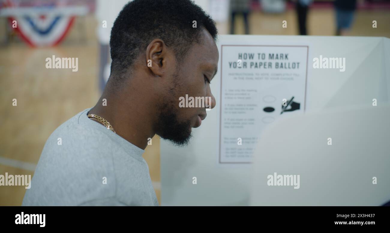 African American male voter comes to voting booth. American citizens ...