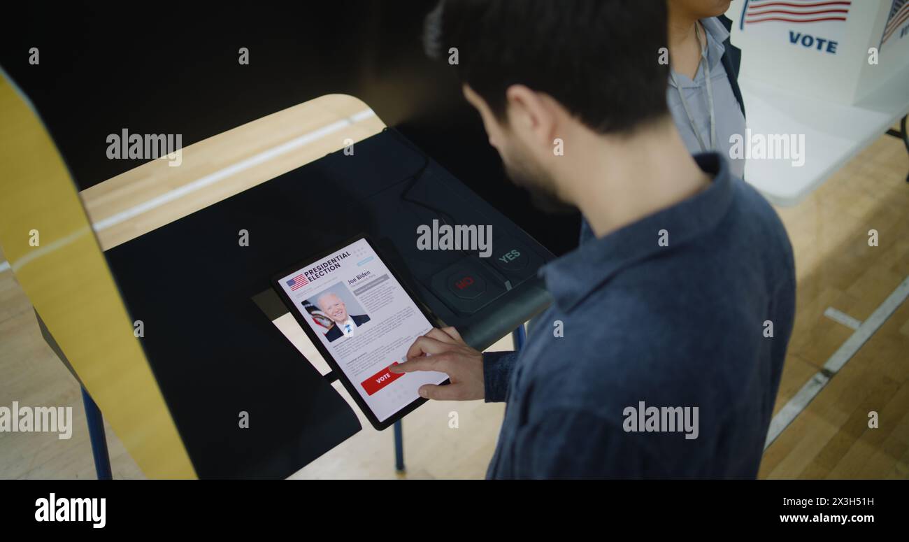 ZAPORIZHYA, UKRAINE -MARCH 15, 2024: High angle of male voter making ...