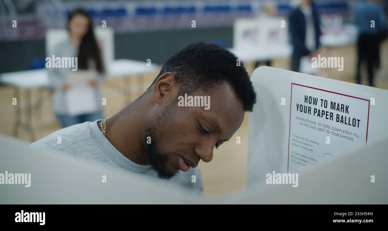 African American male voter comes to voting booth. American citizens ...