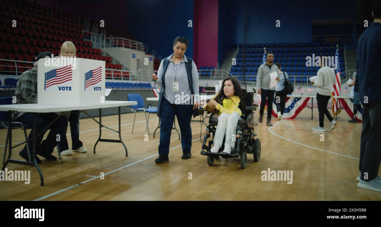 Woman with SMA in electric wheelchair comes with polling officer to ...