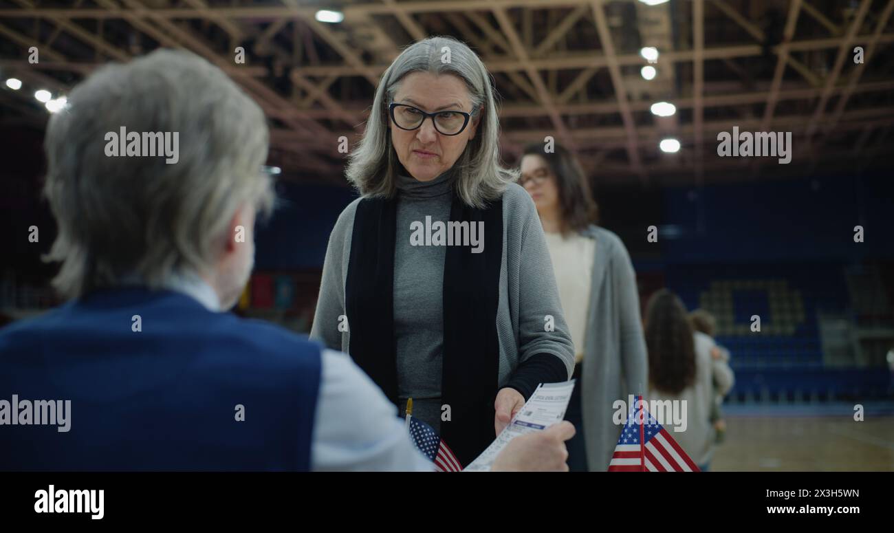 Female American citizen comes to vote in polling station. Political ...