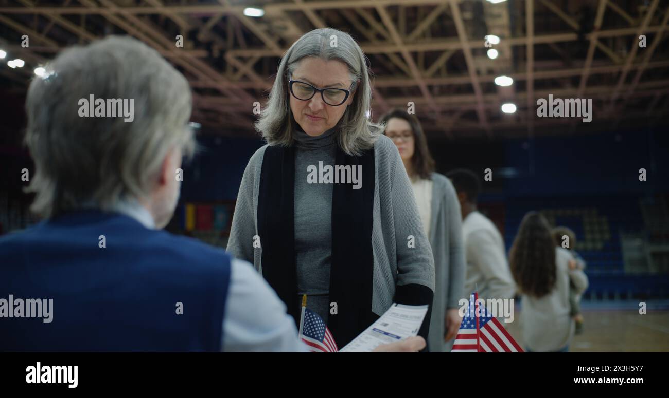 Female American citizen comes to vote in polling station. Political ...
