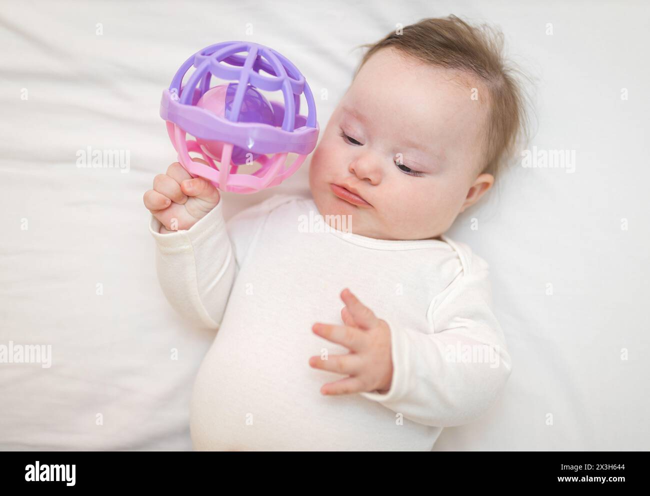Cute Baby Girl Infant Stand on Back in Crib and Play With a Sensory Toy ...