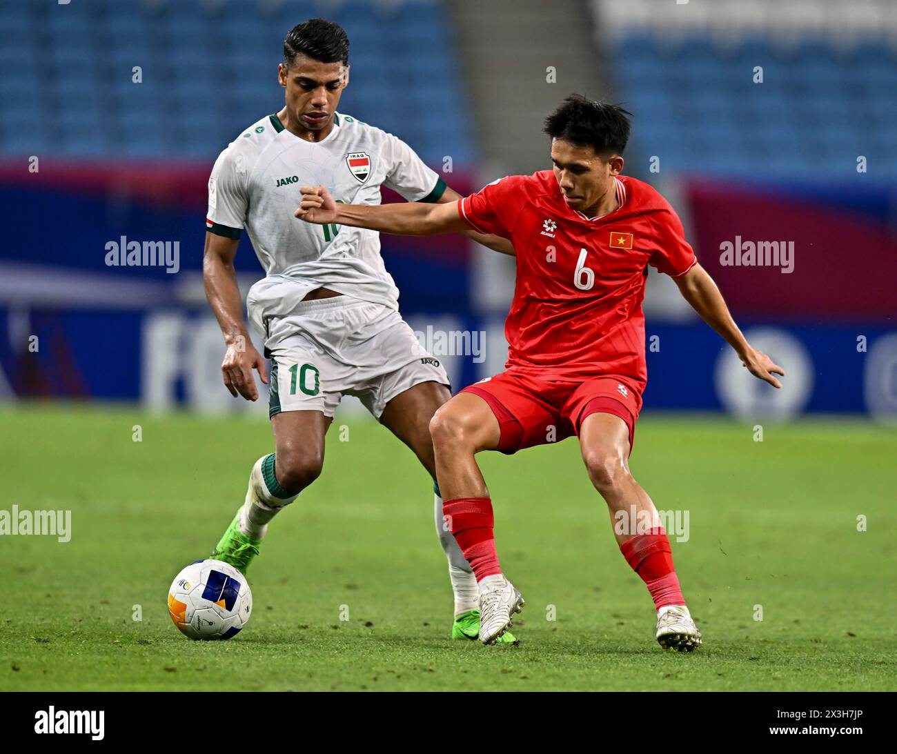 Doha, Qatar. 26th Apr, 2024. Vo Hoang Minh Khoa (R) of Vietnam vies with Nihad Mohammed Watifi ...