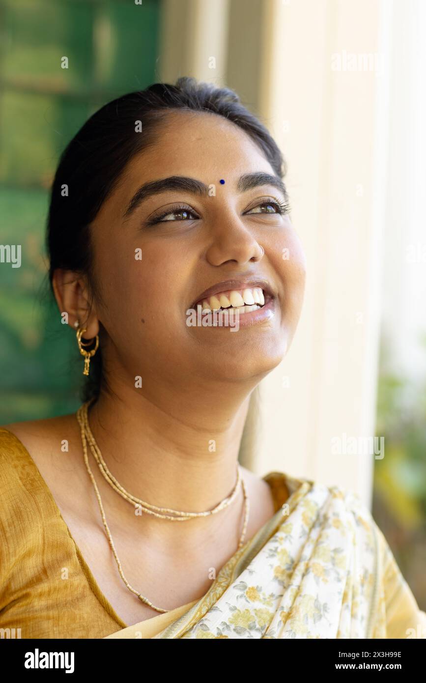 Indian Young Woman Wearing Traditional Clothing Smiling At Home Stock
