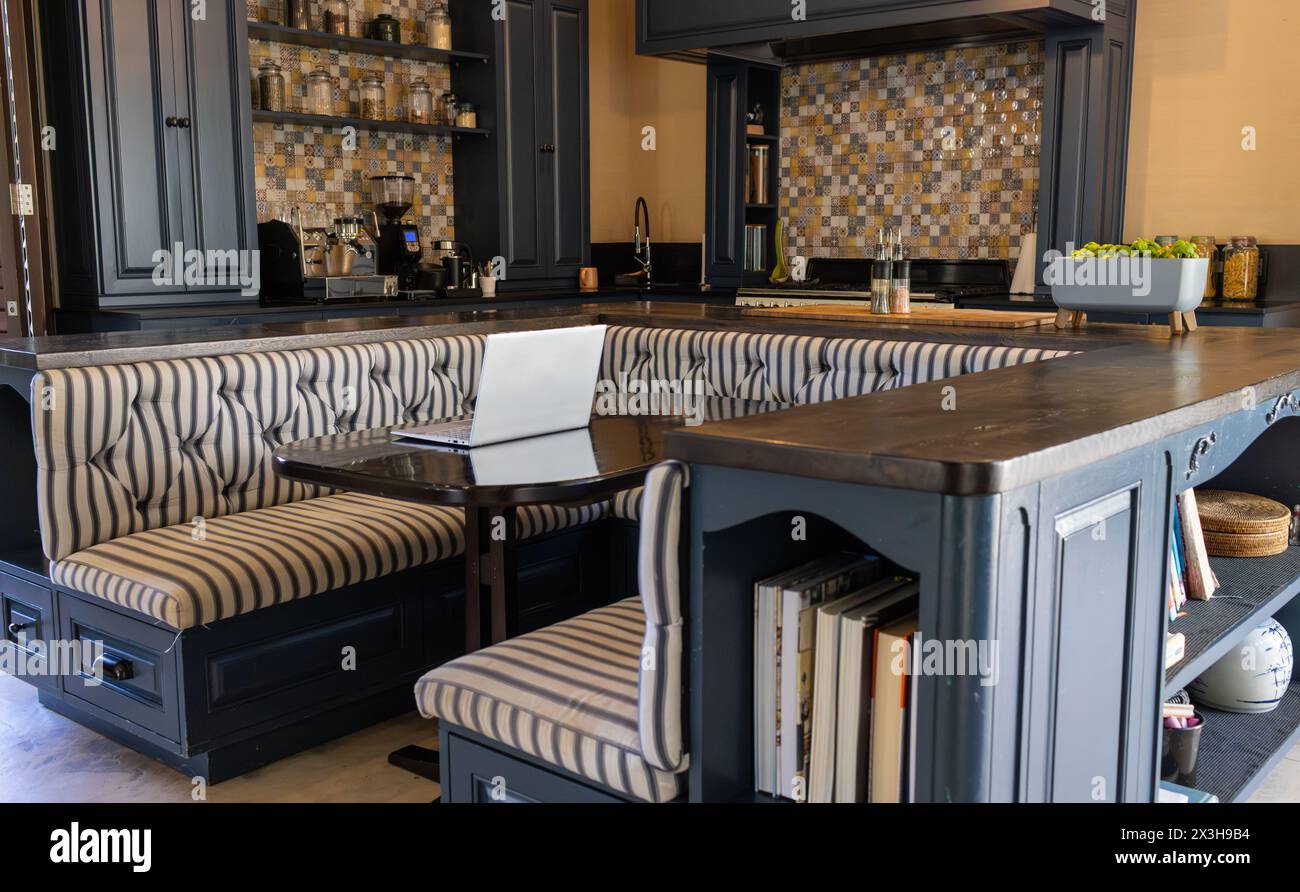 A modern kitchen with striped bench seating and large island Stock ...