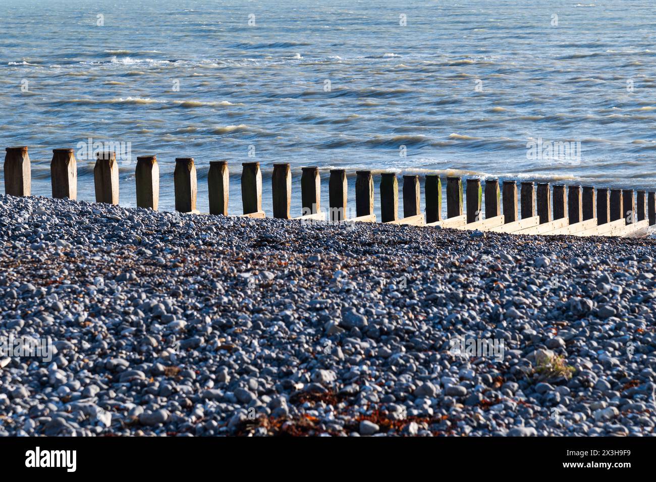 Groynes and sea defences on Eastbourne's shingle beach near Beachy Head ...