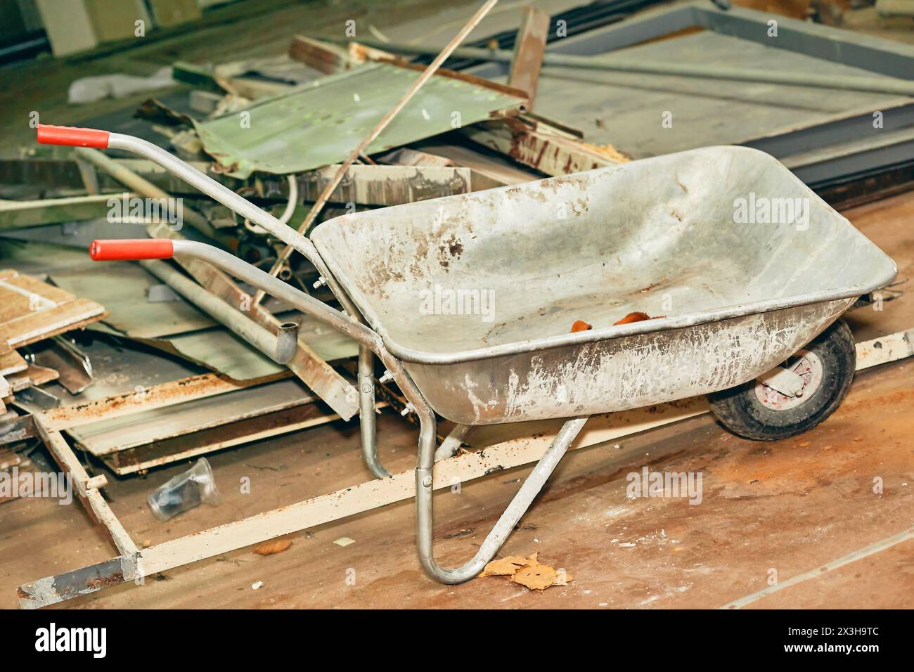 Construction metal wheelbarrow, various waste after repair Stock Photo ...