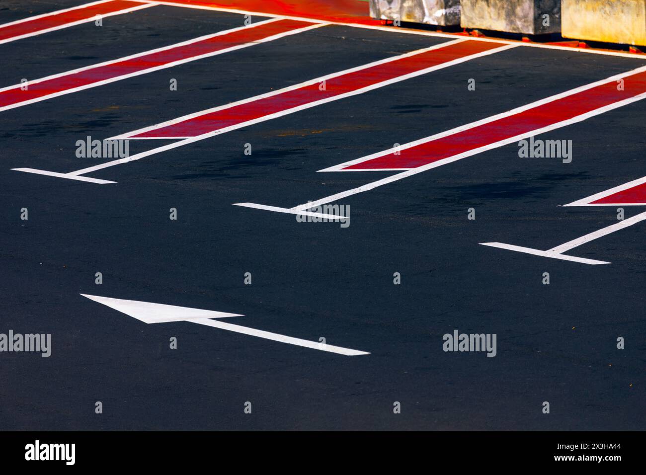 Red and white arrows on a parking lot in the city. Road marking at ...