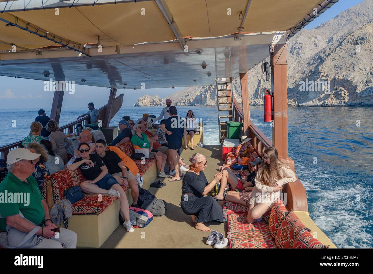 Khasab, Oman - 1 January 2024: Tourists aboard a traditional dhow ...