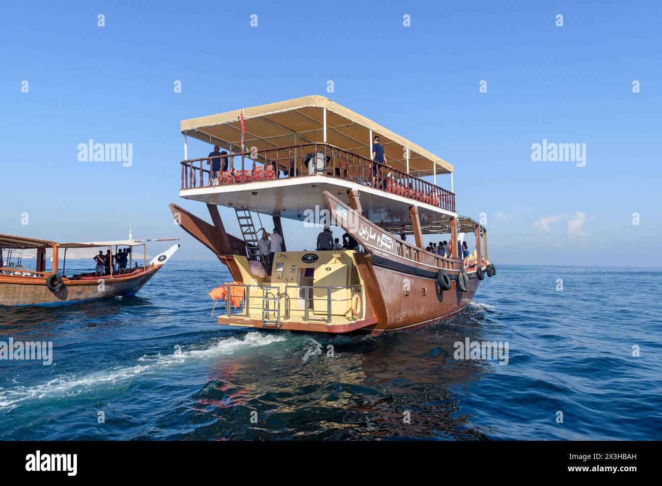 Khasab, Oman - 1 January 2024: Tourists aboard a traditional Omani dhow ...