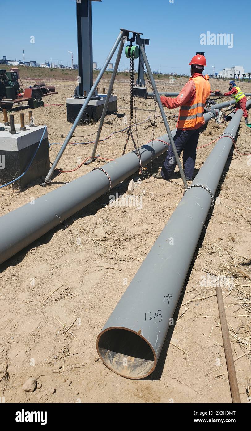 The workers are constructing the steam pipe network for the chemical ...
