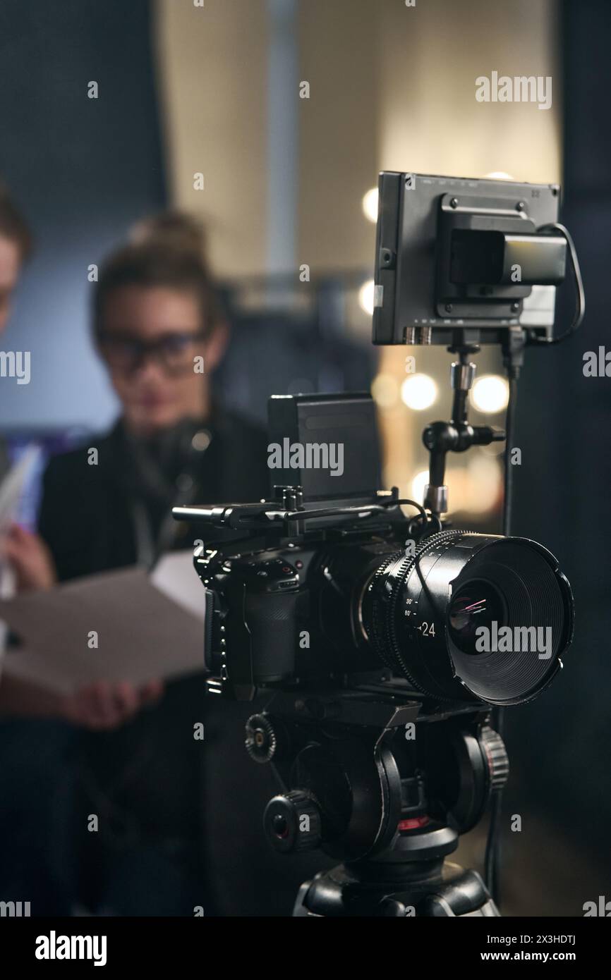 Vertical background image of pro digital video camera set up on stand ...