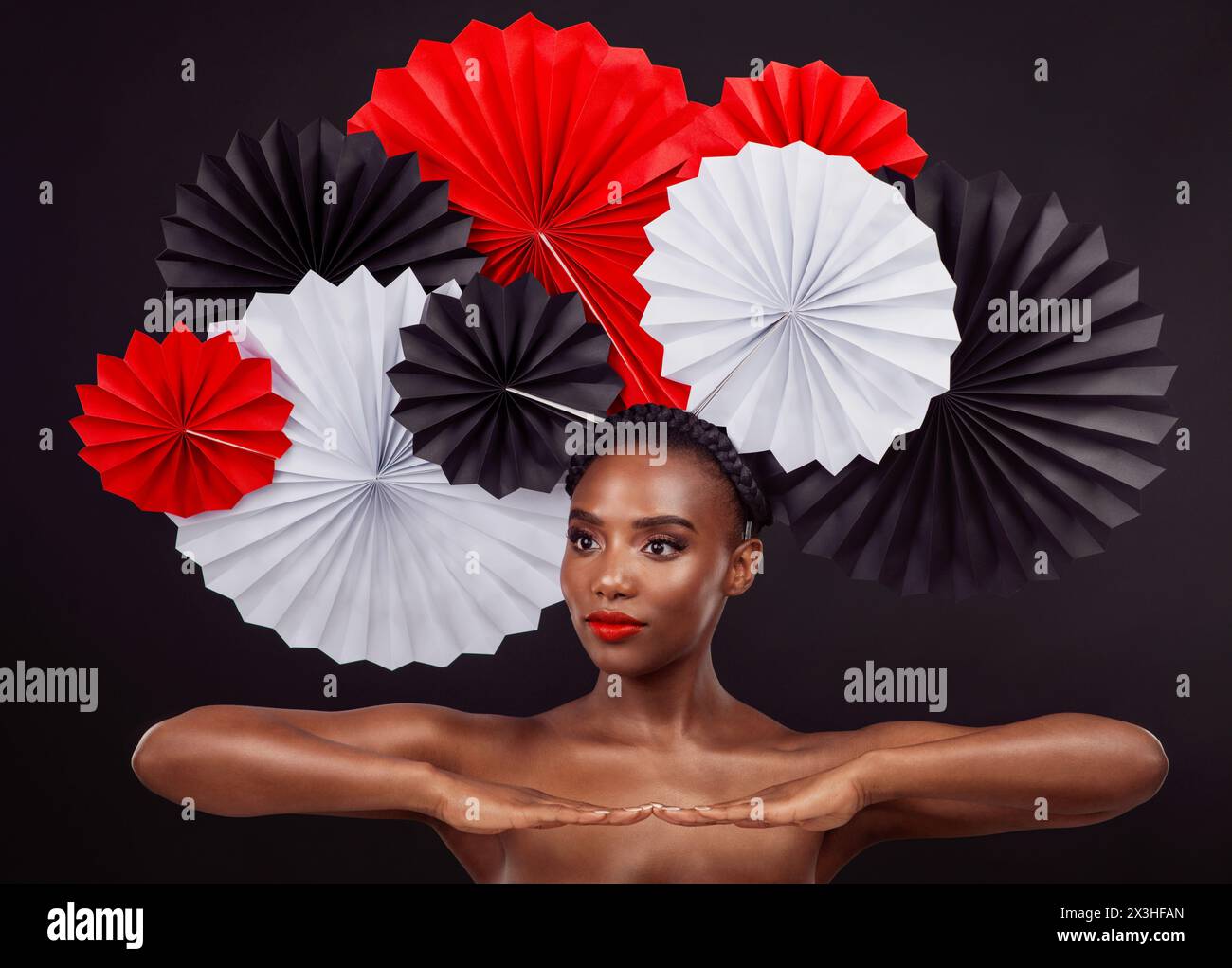 Woman, beauty and hand with origami fans in studio isolated on a dark ...
