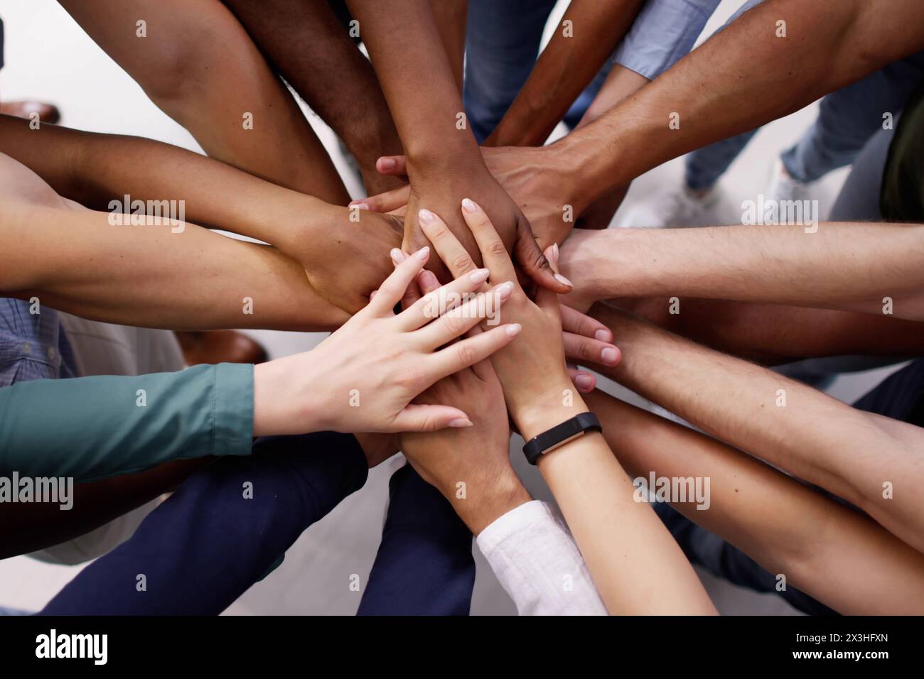 African business team huddle, hands together in unity Stock Photo - Alamy