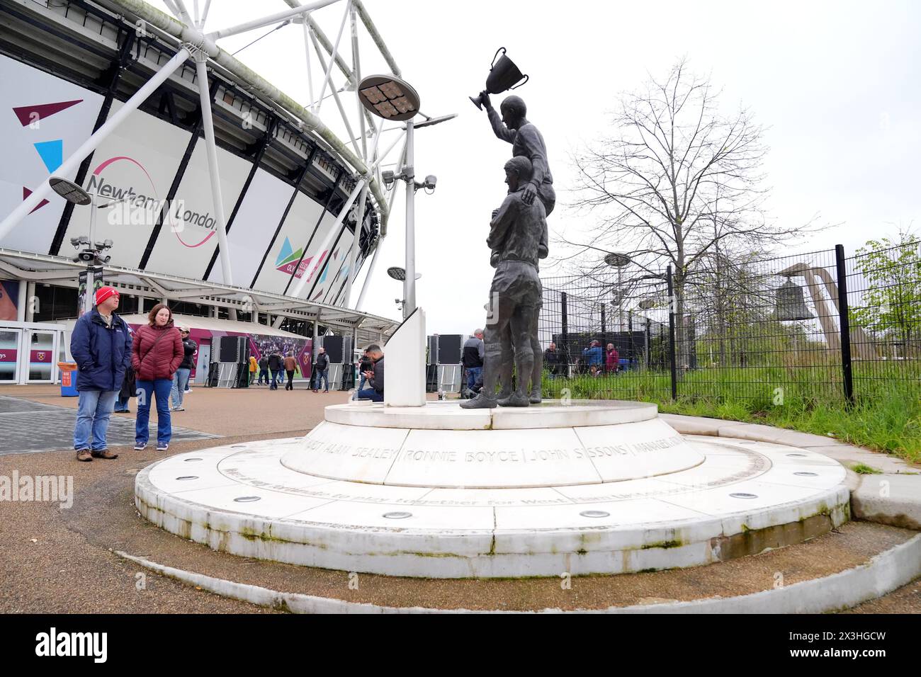 Liverpool fans look at the statue commemorating Bobby Moore, Sir Geoff ...