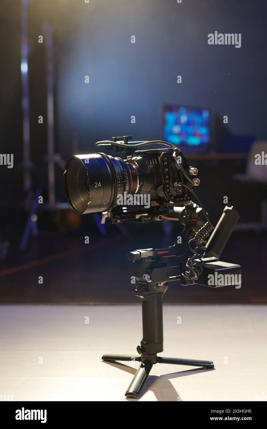 Vertical background image of pro digital camera on stabilizer stand in ...