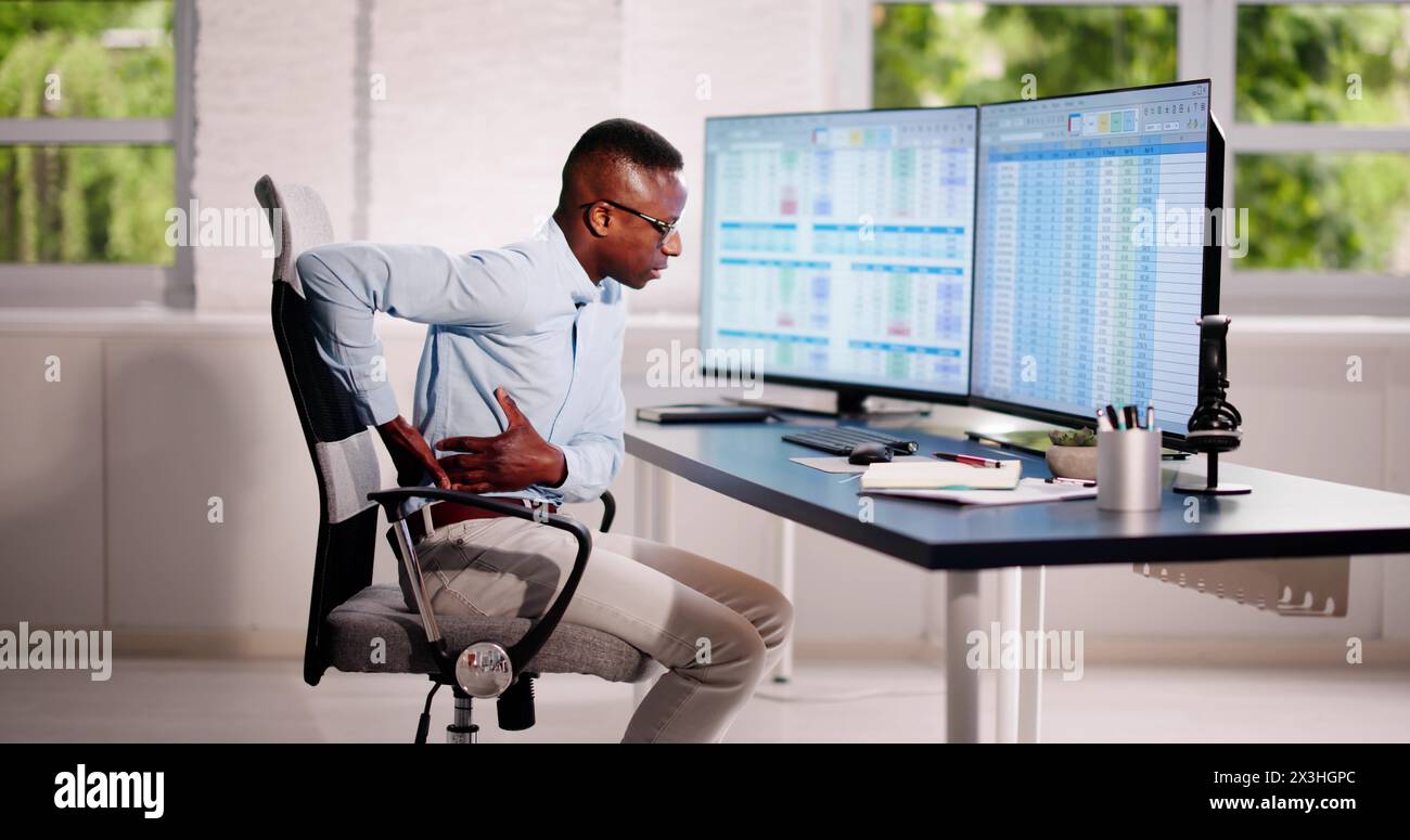 Back Pain Bad Posture Man Sitting In Office Stock Photo - Alamy