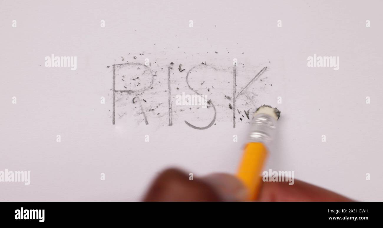 Pencil Eraser Erasing Risk Text On White Paper Stock Photo - Alamy