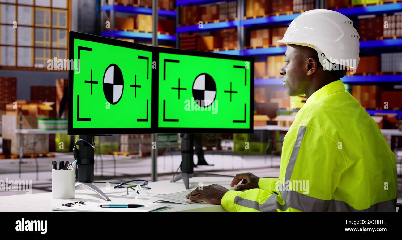 Engineer Using PC Monitor With Green Screen At Warehouse Stock Photo ...