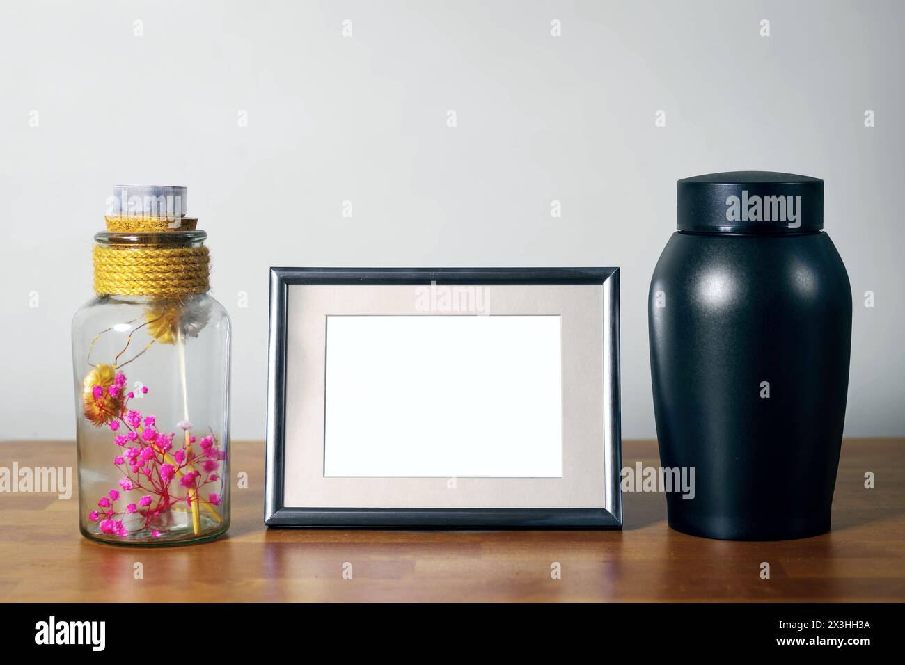 Funeral mourning urn , next to a picture frame on the table. Horizontal ...