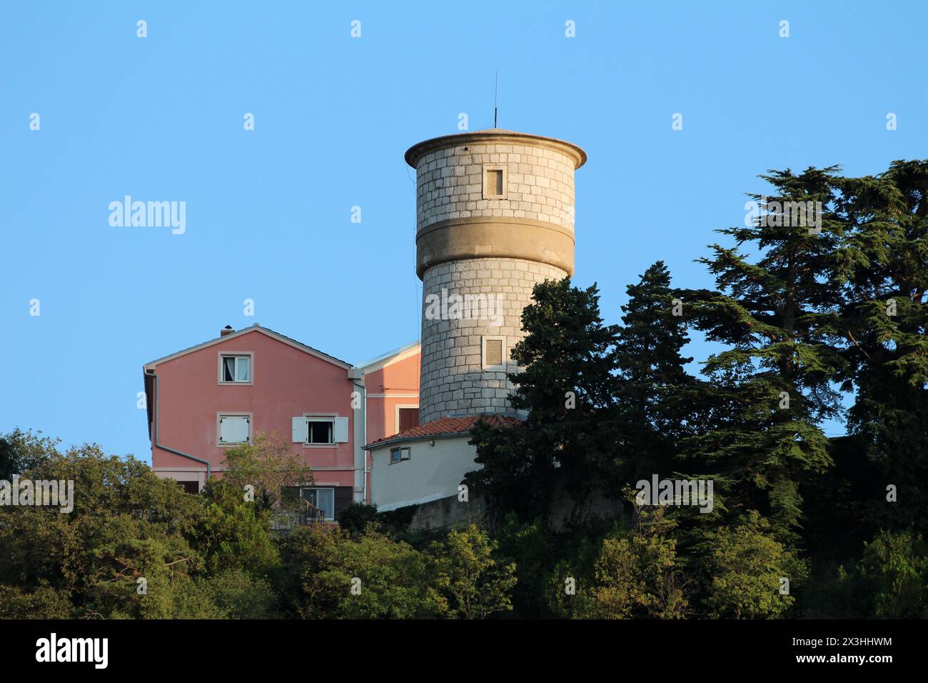 Newly built building designed as medieval castle tower with concrete ...