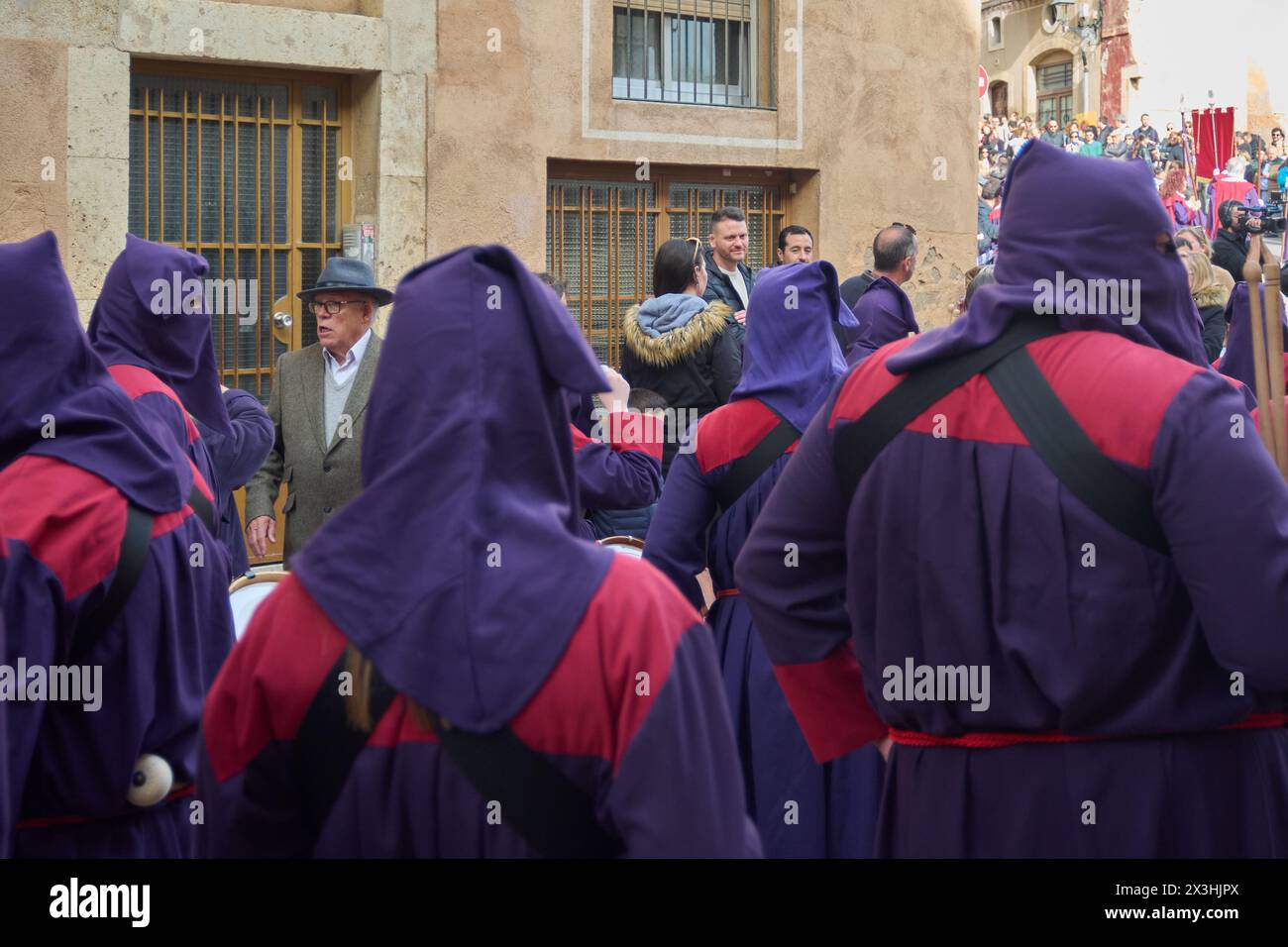 Tarragona, Spain - April 27, 2024: Devout participants in red robes and ...