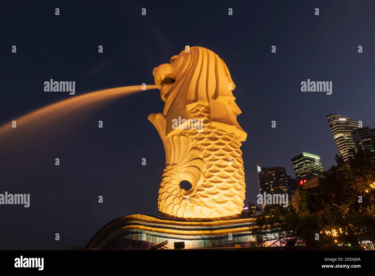 The Merlion statue in Singapore illuminated at night Stock Photo - Alamy
