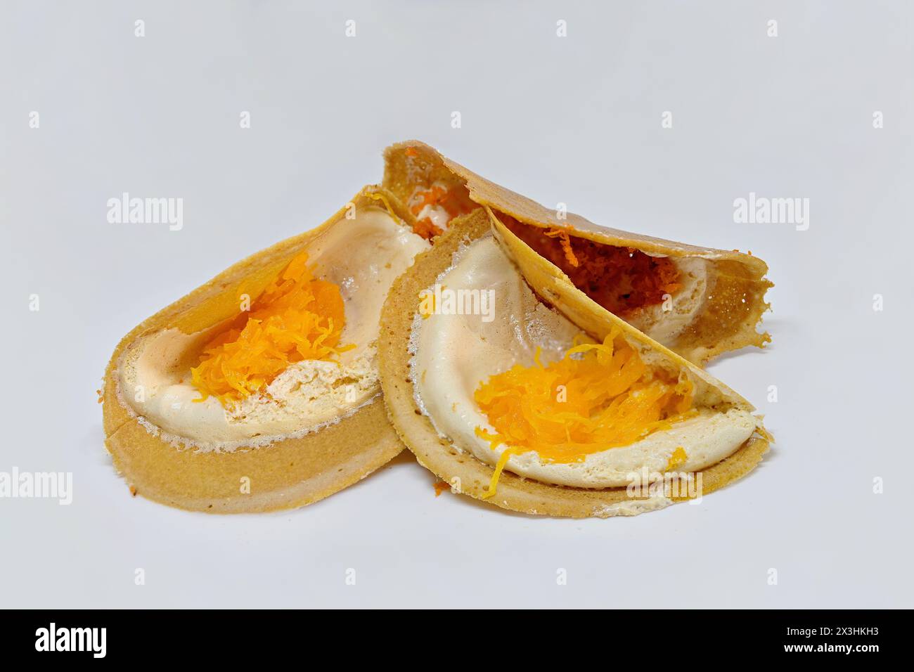 Khanom Bueang or Thai crispy pancakes, topped with Foi Thong (sweet egg ...