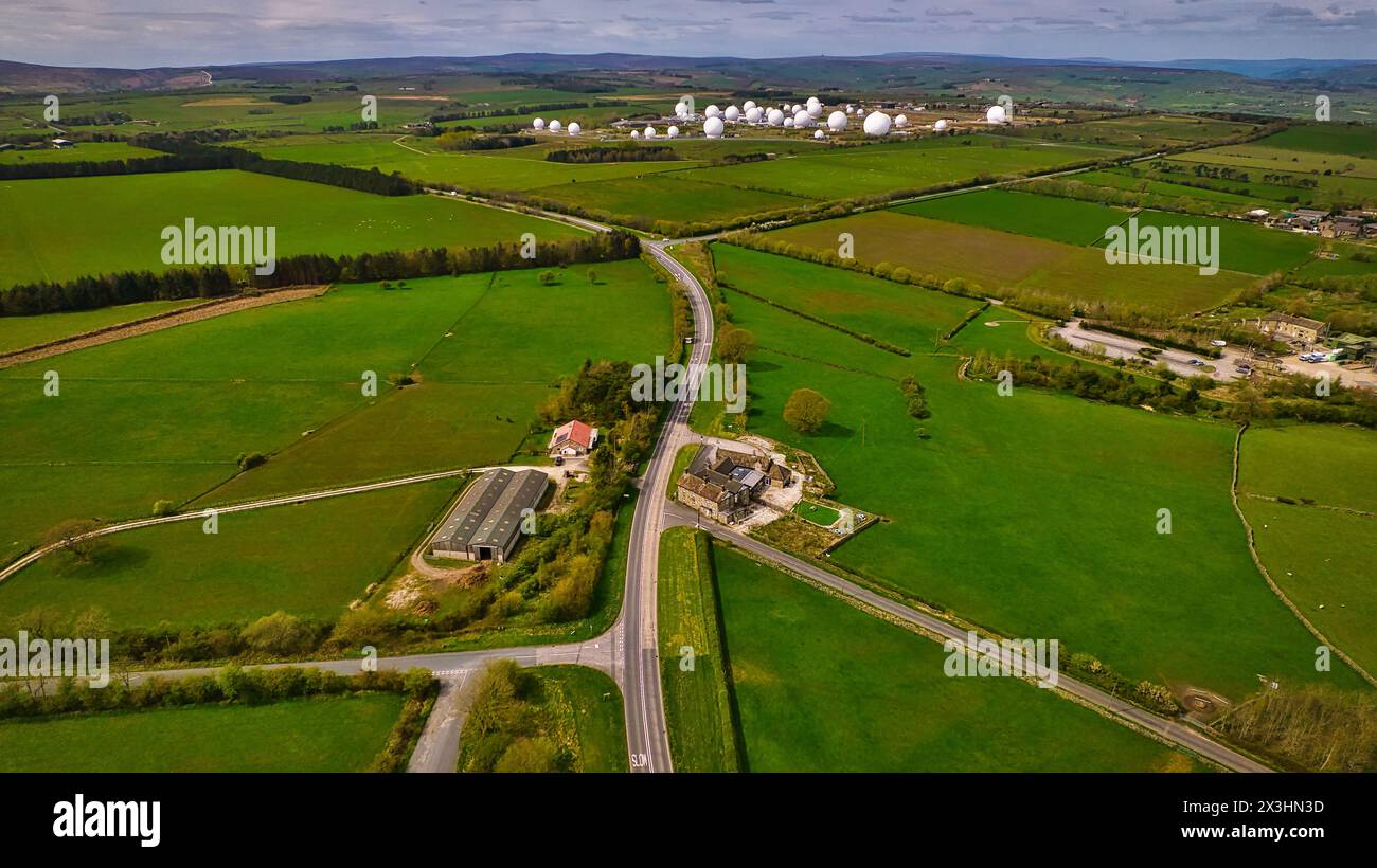 Aerial view of a rural landscape with a road dividing green fields and ...